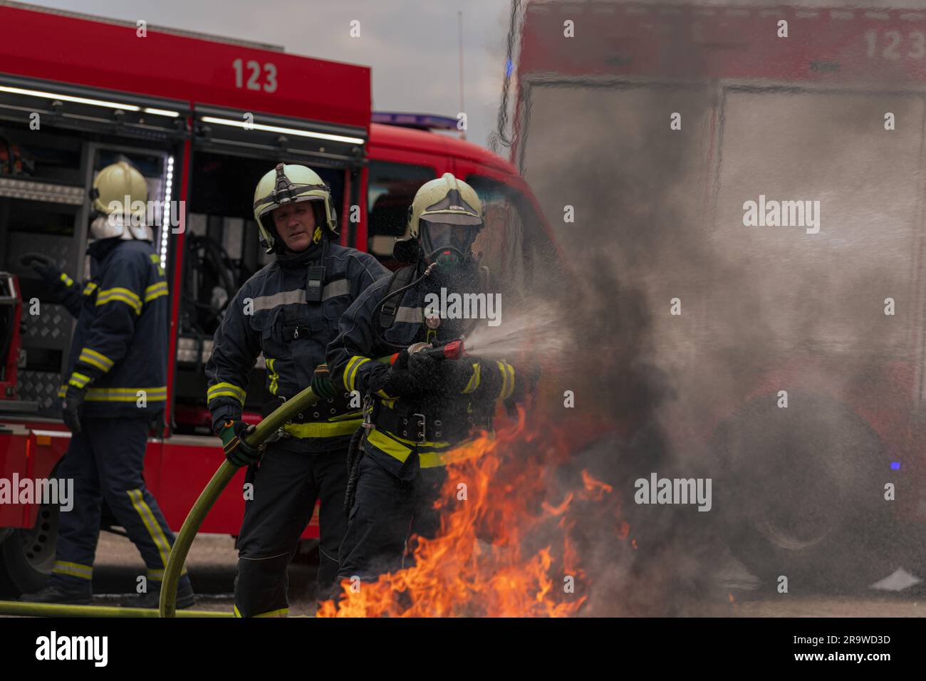 Firefighters fight the fire flame to control fire not to spreading out ...