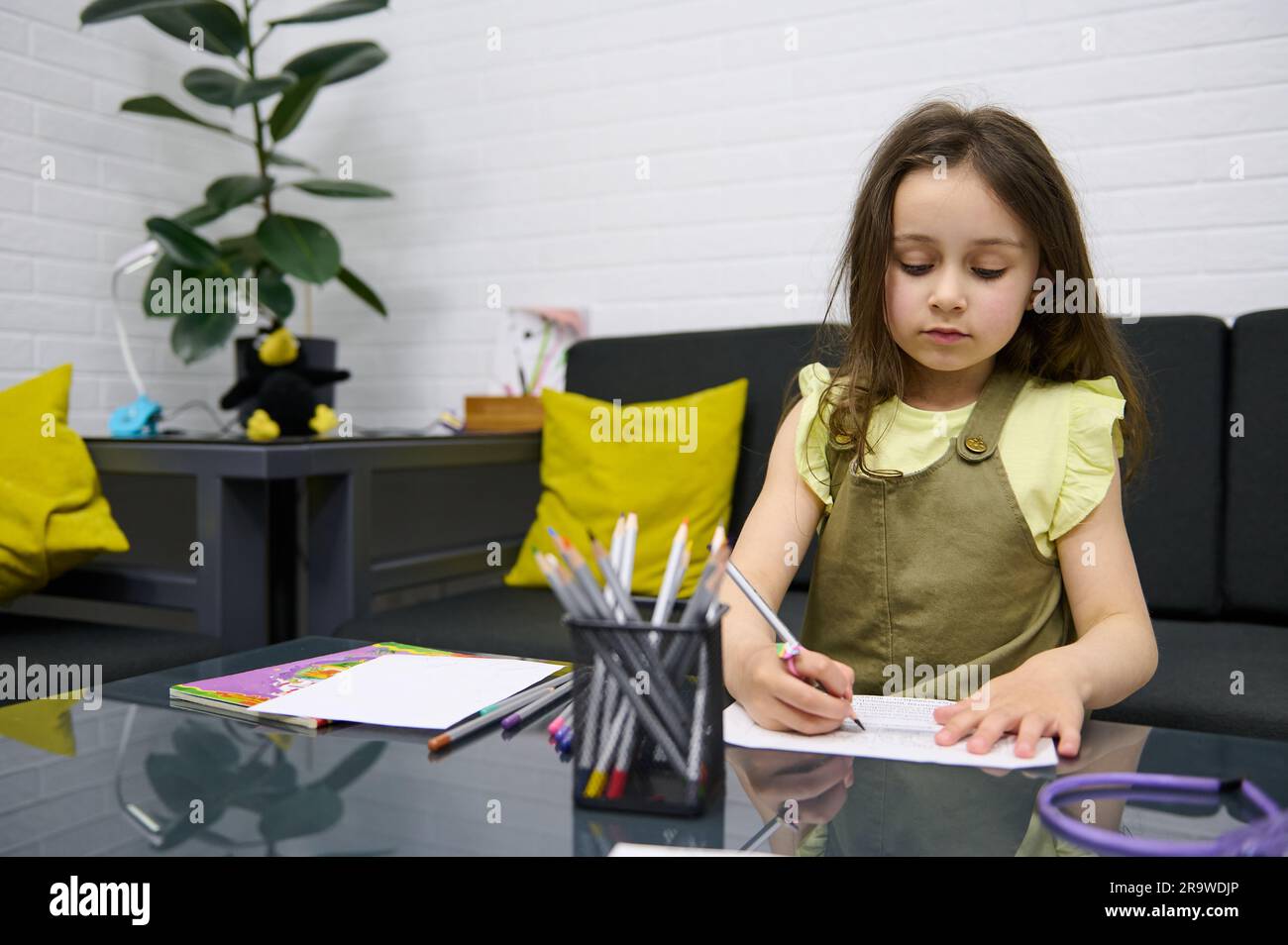 Beautiful primary school child girl drawing pictures with colorful ...