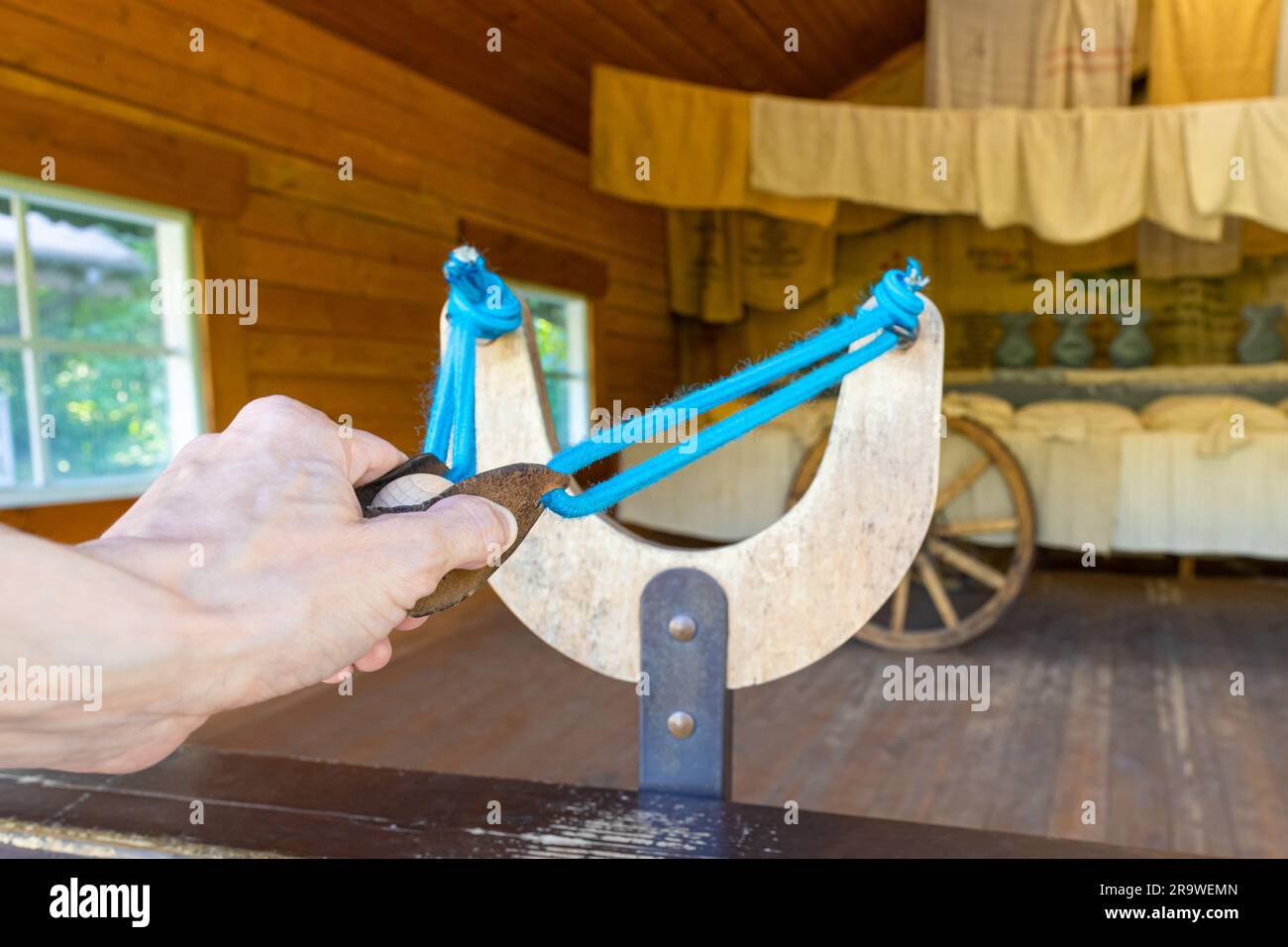 a man in a shooting range shoots a slingshot. target shooting. High ...