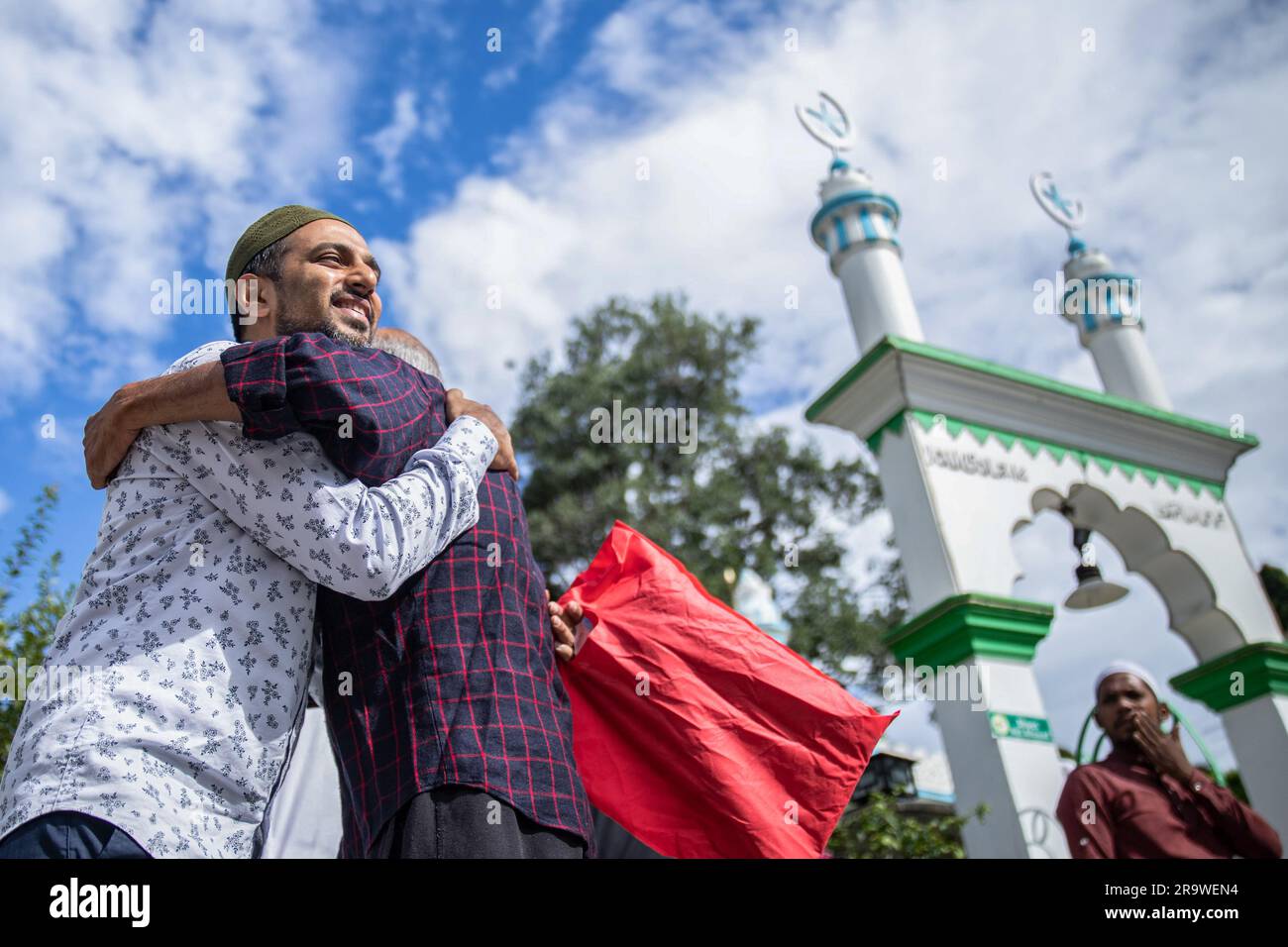 Kathmandu, Nepal. 29th June, 2023. Nepali Muslims hug each other to ...