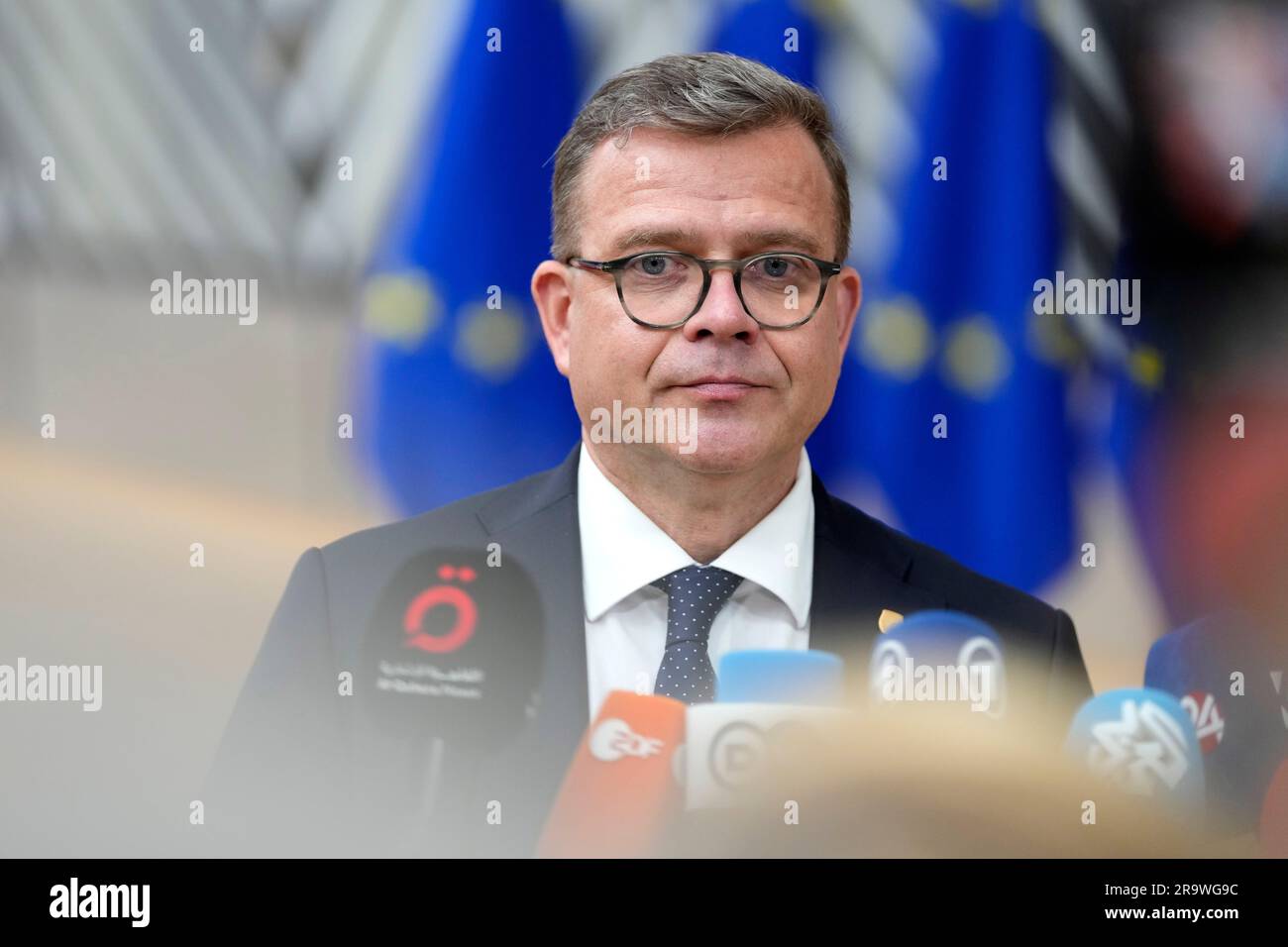 Finland's Prime Minister Petteri Orpo speaks with the media as he arrives for an EU summit at ...