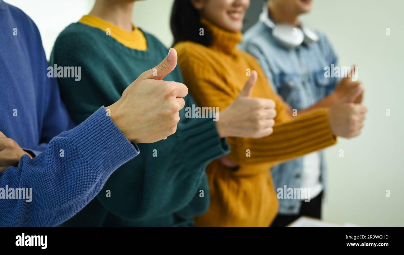 Group of setup businesspeople showing thumbs up, gesturing in the ...