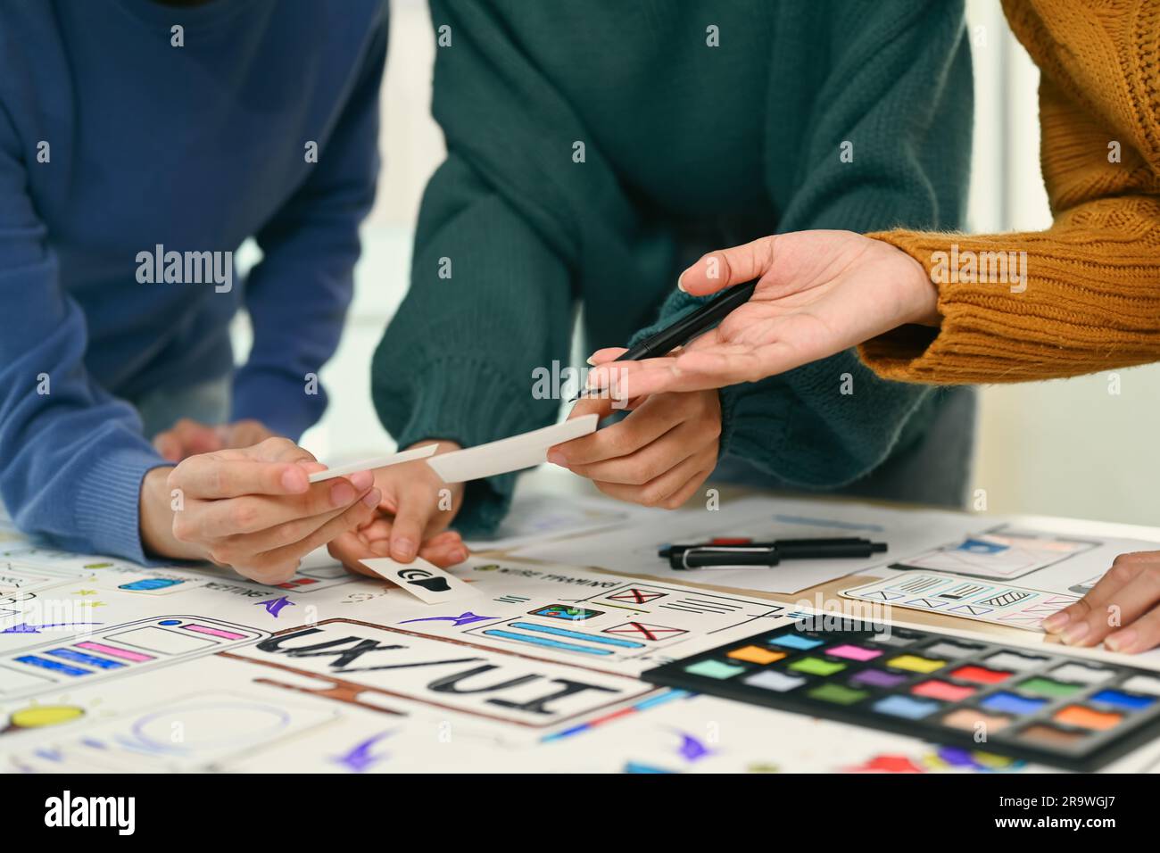 Group Of Application Designers Testing And Discussing On New App Features Collaborating On New