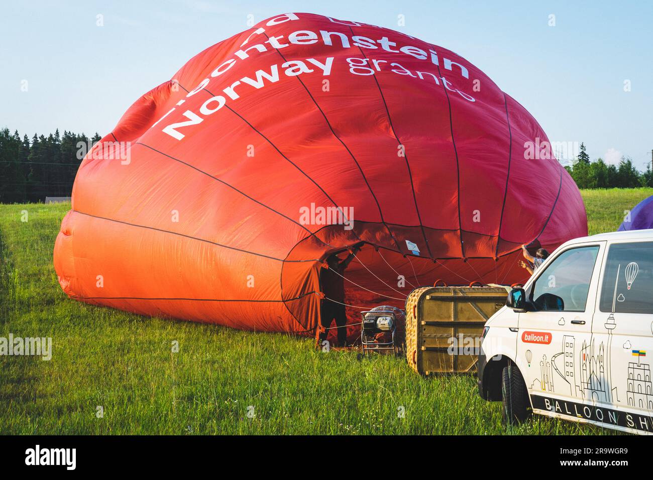 Hot Air Balloon Flight over Trakai. Inflating the hot air balloon in a ...