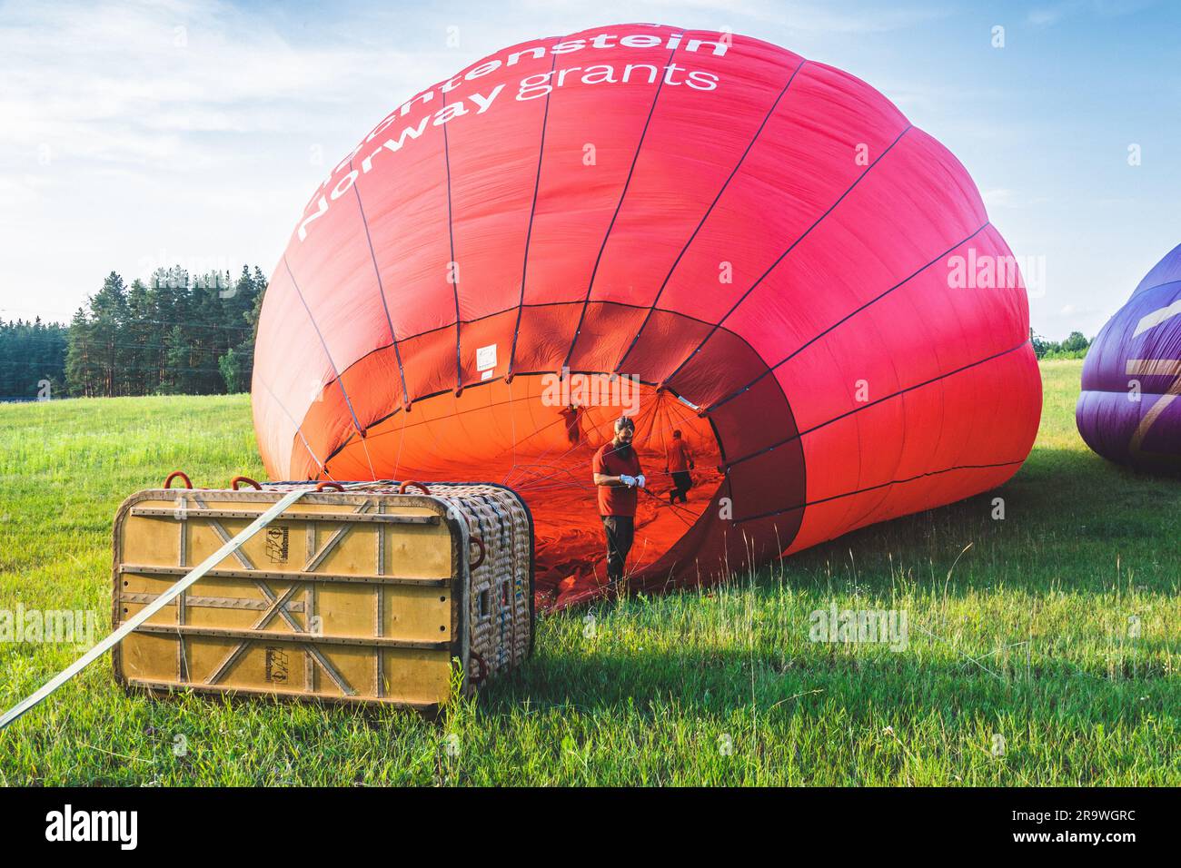 Hot Air Balloon Flight over Trakai. Inflating the hot air balloon in a ...