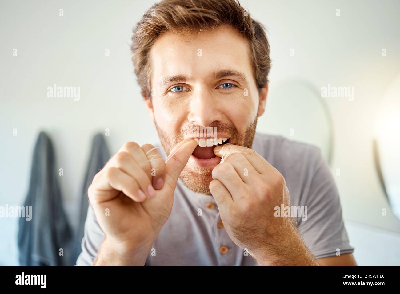 Teeth, dental floss and portrait of man in bathroom for self care, oral ...