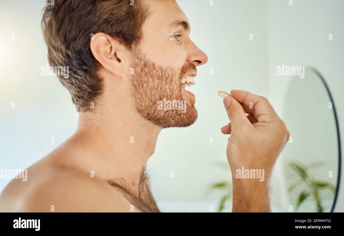 Home bathroom, face and man eating tablet, pills or morning antibiotics ...