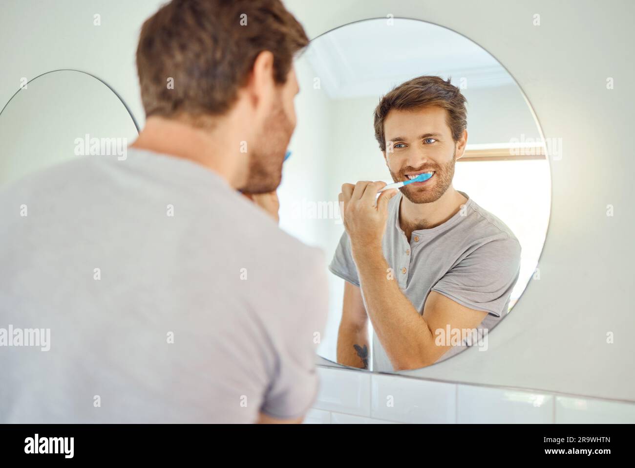 Brushing teeth, morning routine and mirror with man in bathroom for ...