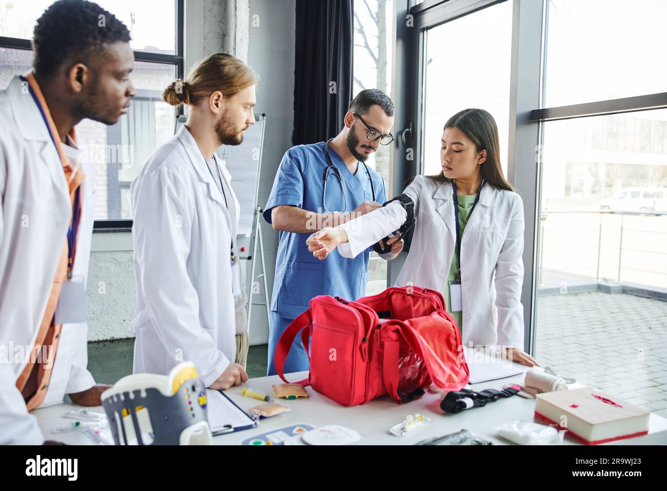 healthcare worker in eyeglasses and uniform applying compressive ...