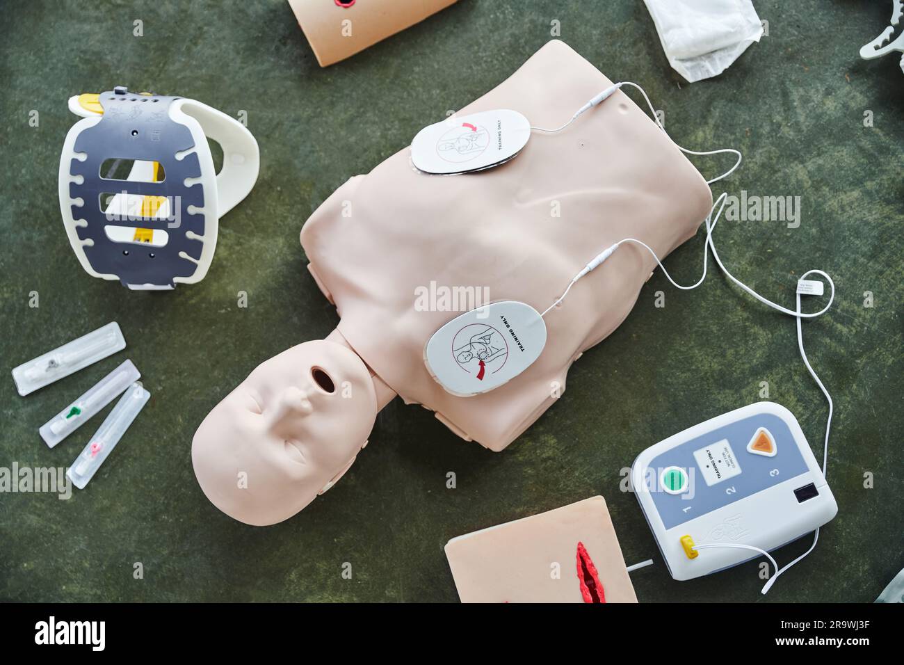 top view of CPR manikin near automated defibrillator, wound care ...