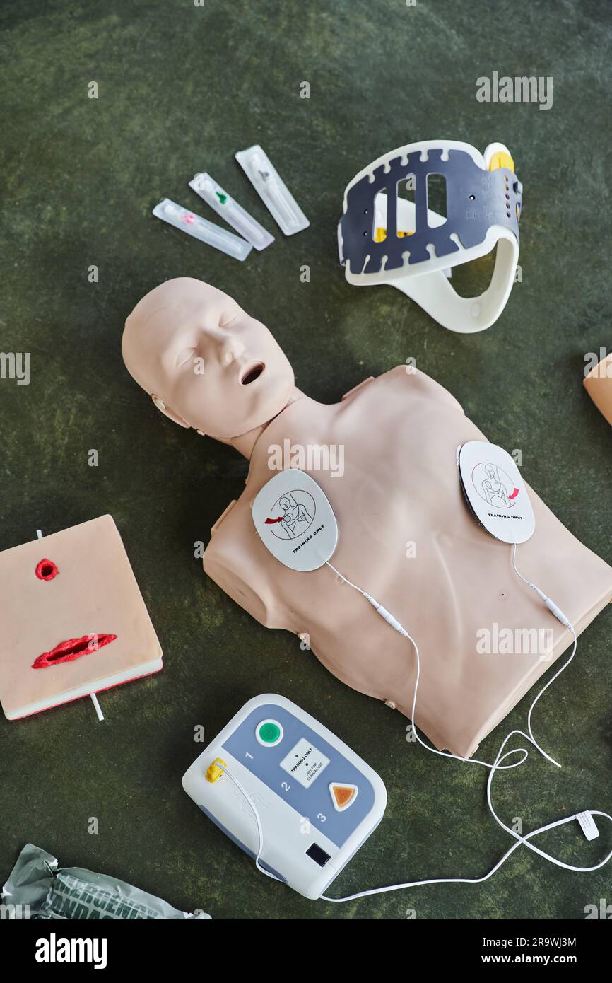 top view of CPR manikin, automated external defibrillator, wound care simulator, neck brace and ...