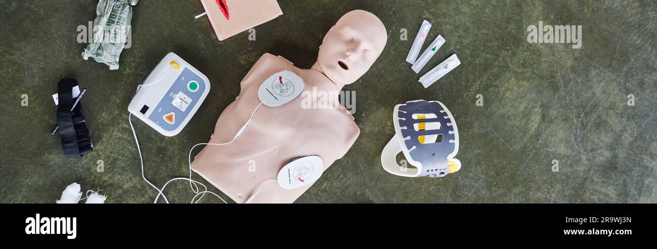 top view of automated external defibrillator, neck brace, syringes, compression tourniquet and ...