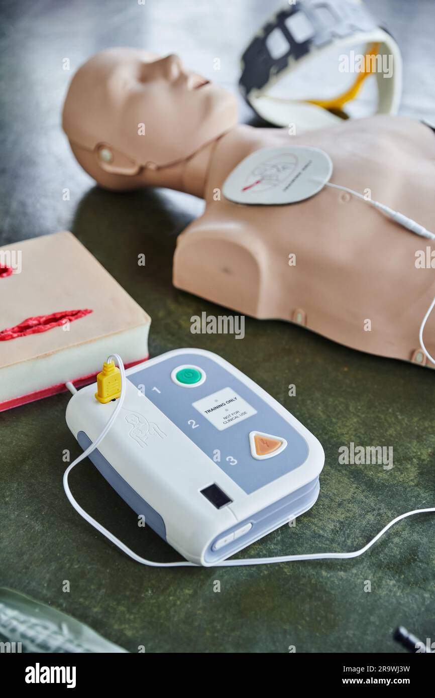 automated external defibrillator near wound care simulator, CPR manikin and neck brace on ...