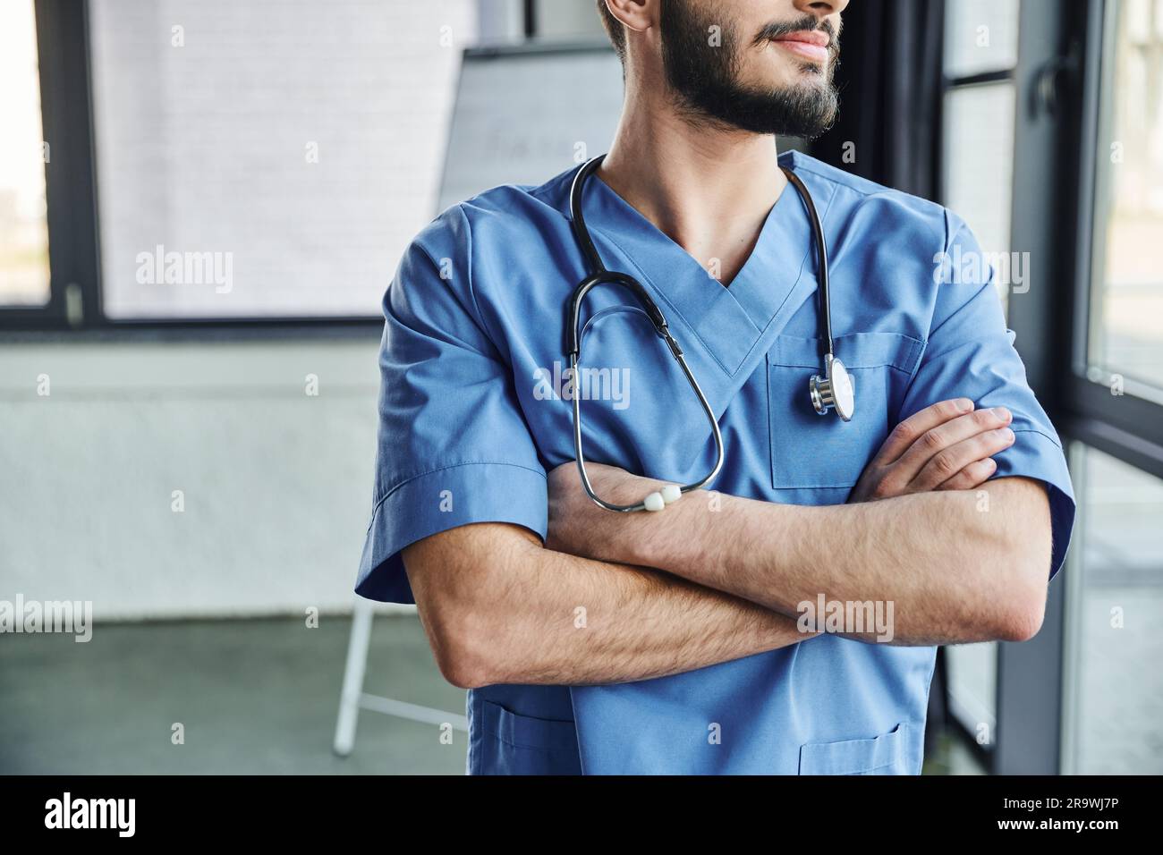 partial view of professional bearded medical instructor in blue uniform ...