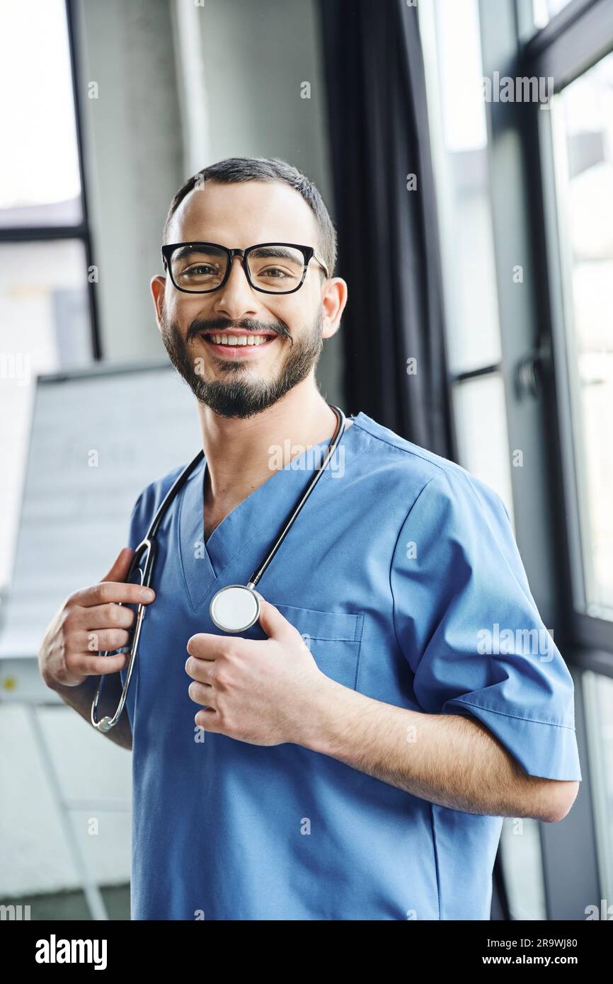 overjoyed bearded medical instructor with stethoscope on neck wearing ...