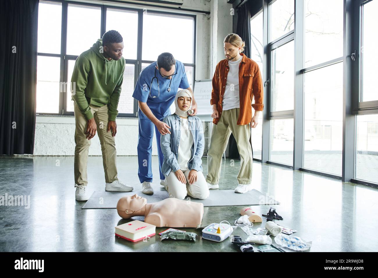 hands-on first aid learning, young interracial men looking at ...