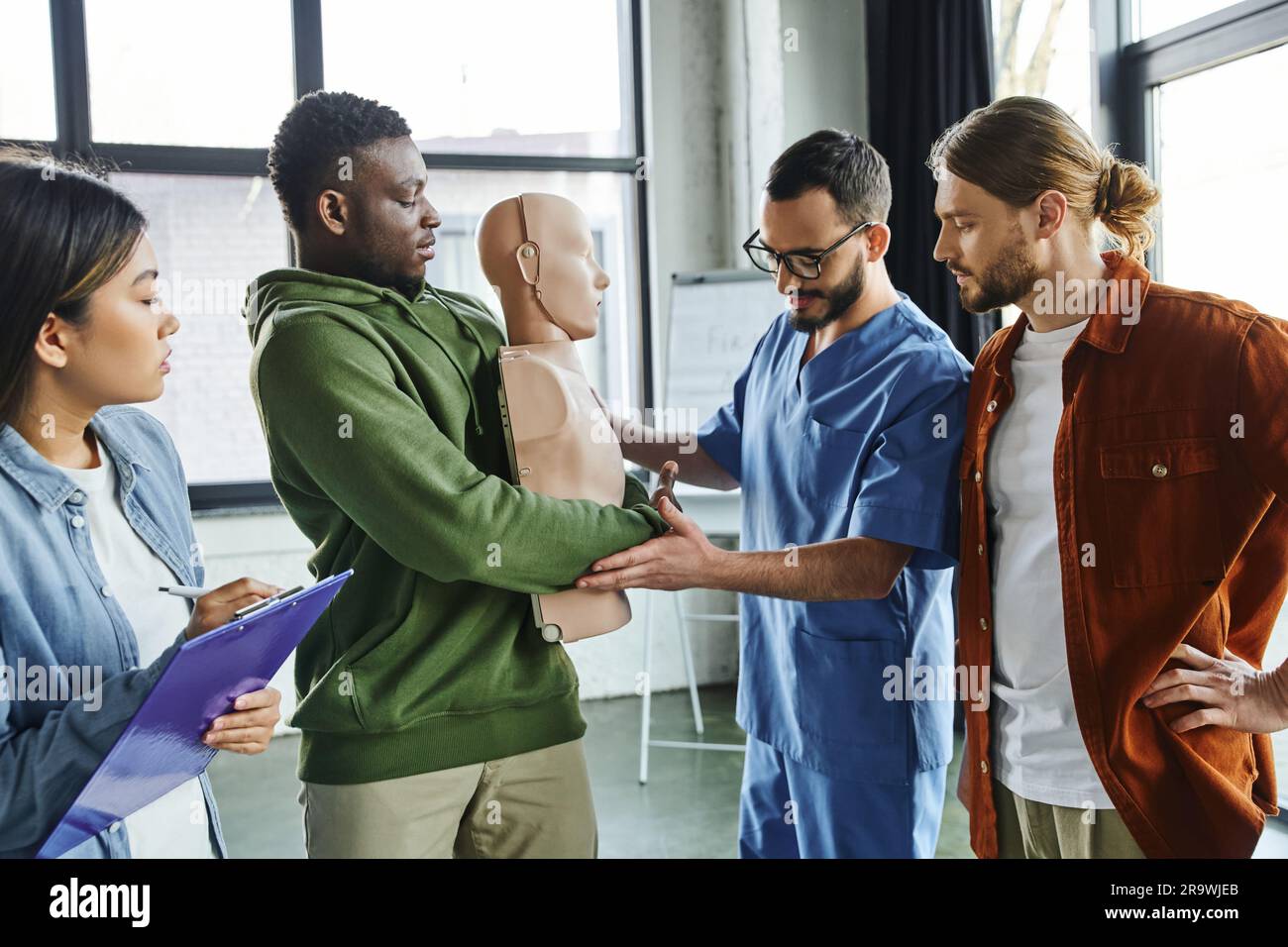 medical instructor assisting african american man practicing life ...