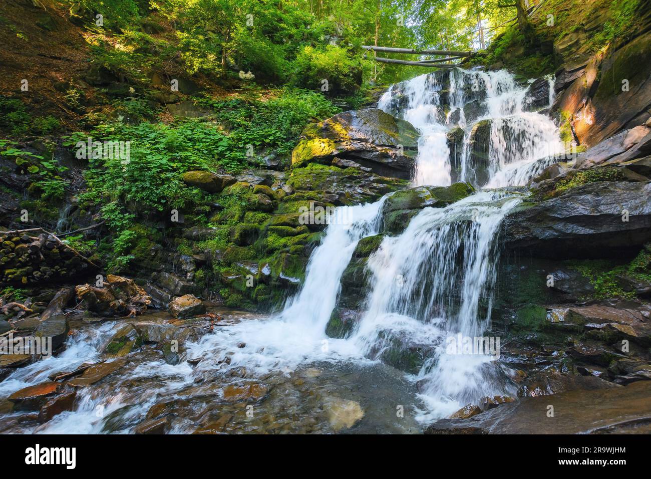 waterfall among wet rocks. fresh environment and clear water concept ...