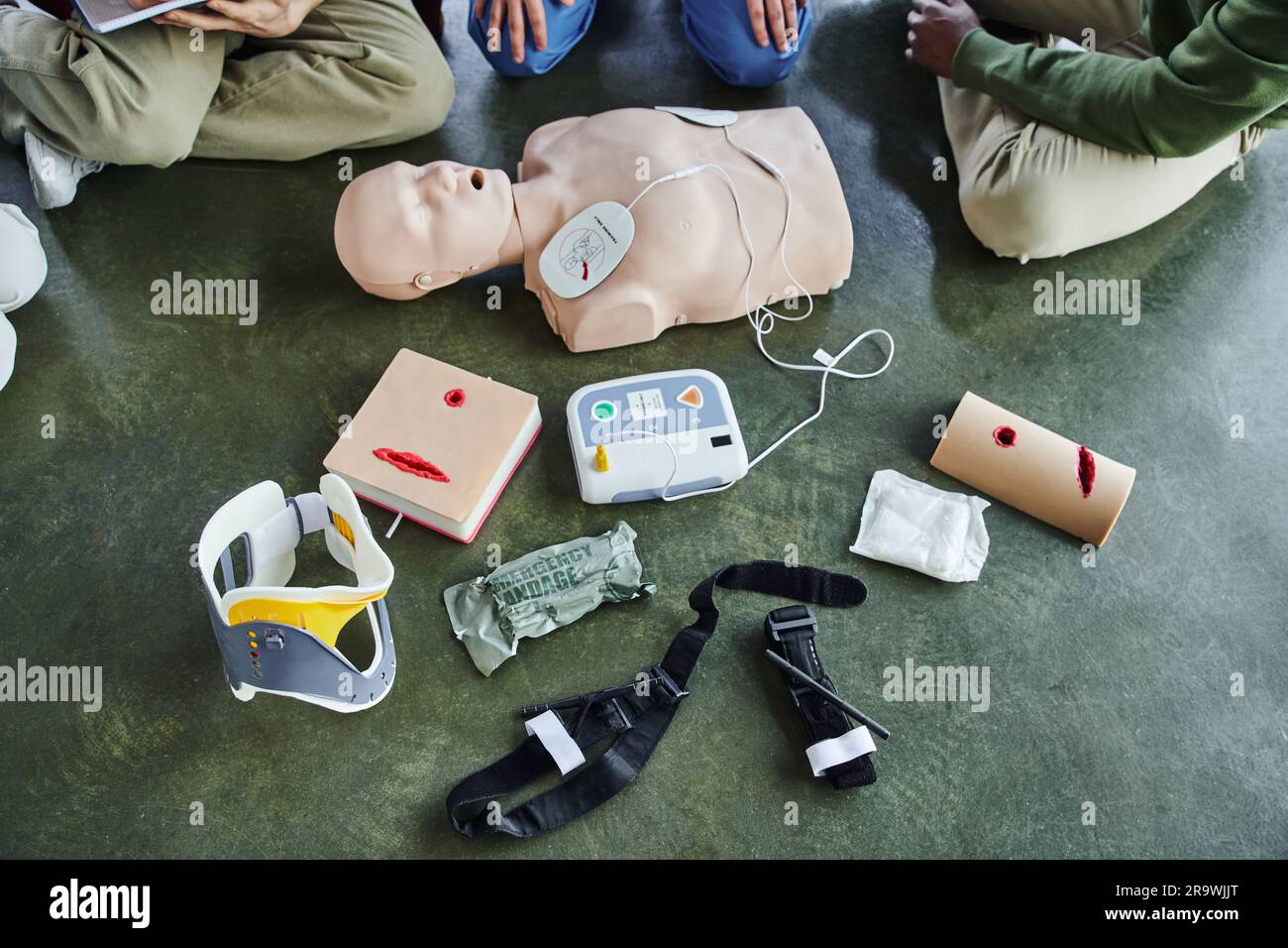 cropped view of multiethnic participants of first aid seminar near CPR ...