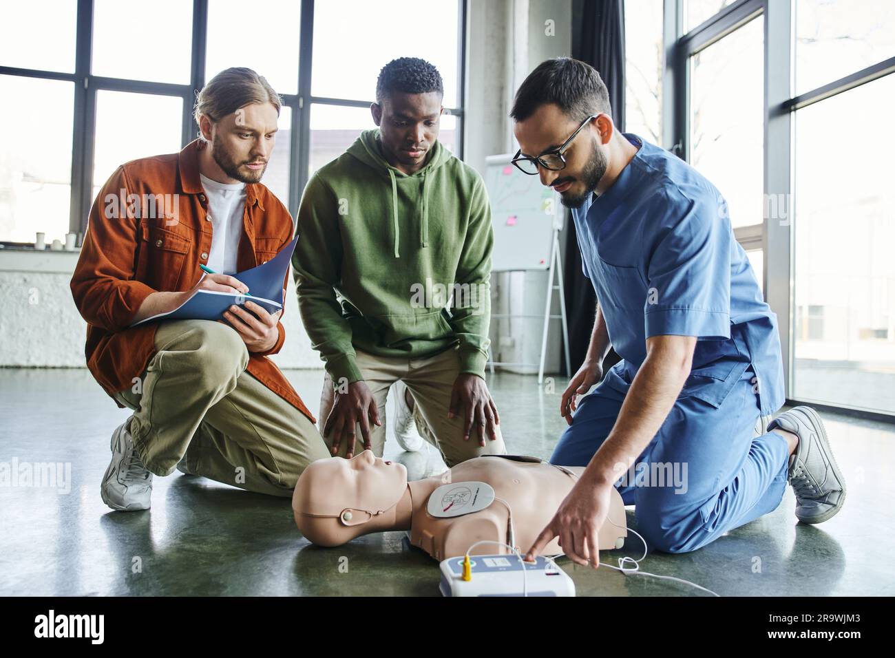 cardiac resuscitation, young man writing in notebook near african ...