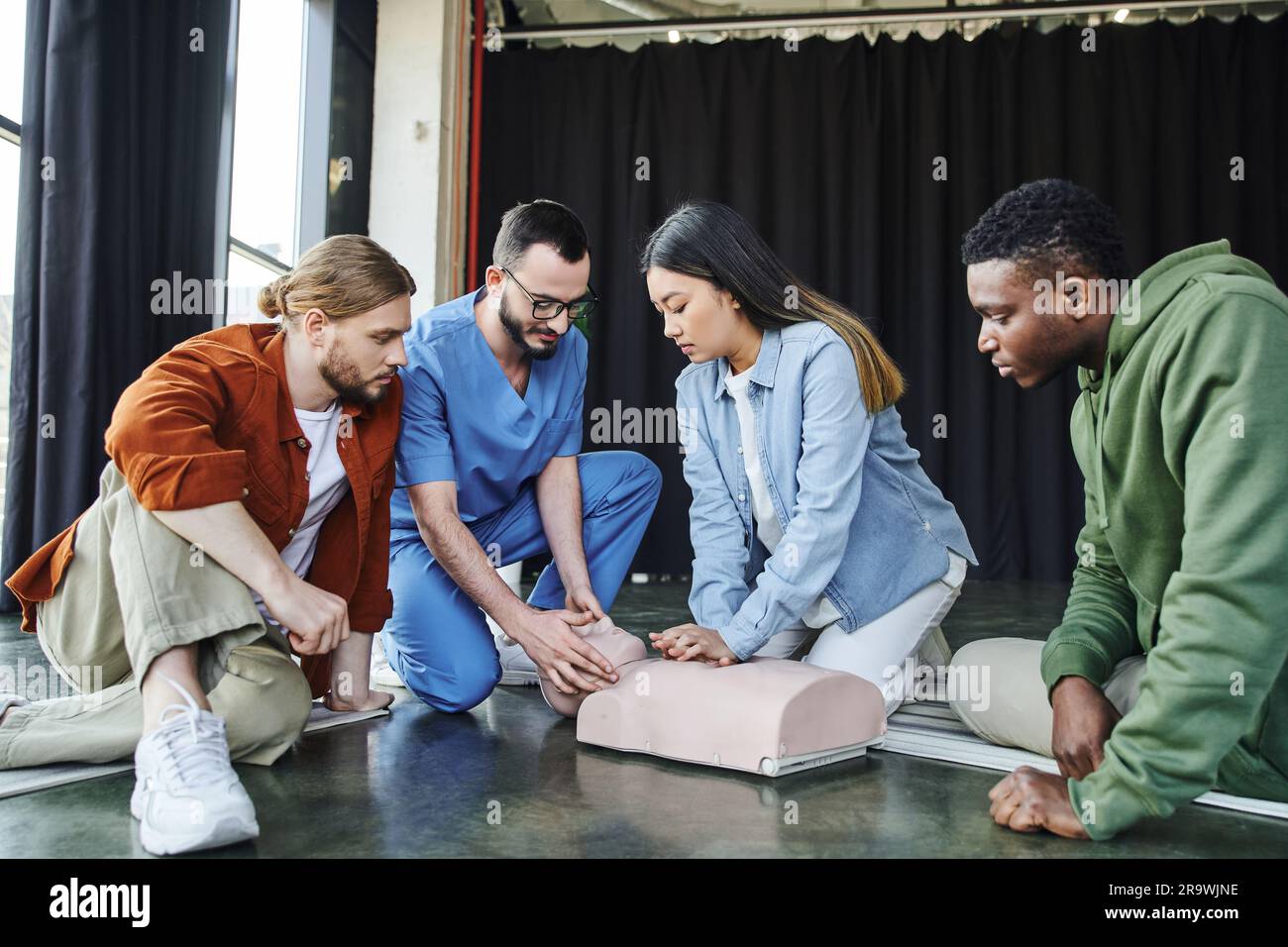 medical seminar, first aid training, cardiopulmonary resuscitation, healthcare worker assisting ...