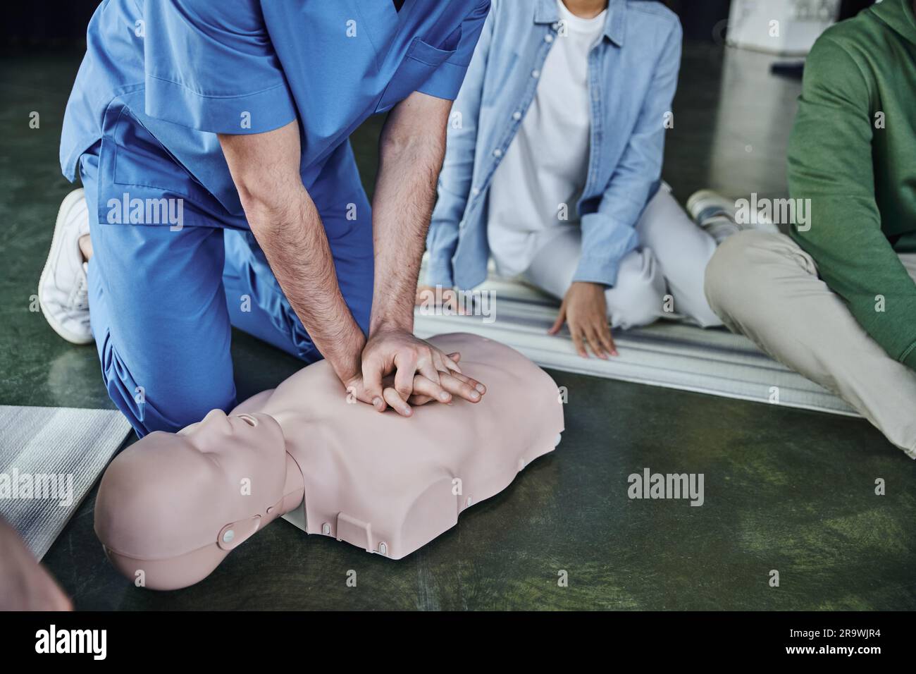 cardiopulmonary resuscitation, partial view of medical instructor doing chest compressions on ...