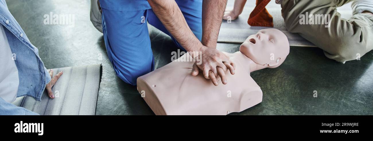 first aid seminar, hands-on learning, cropped view of paramedic showing ...