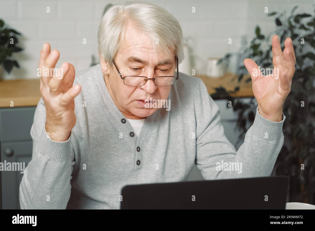 Old man outraged sitting at Laptop. Pensive Mature Grey hair 60s 70s ...