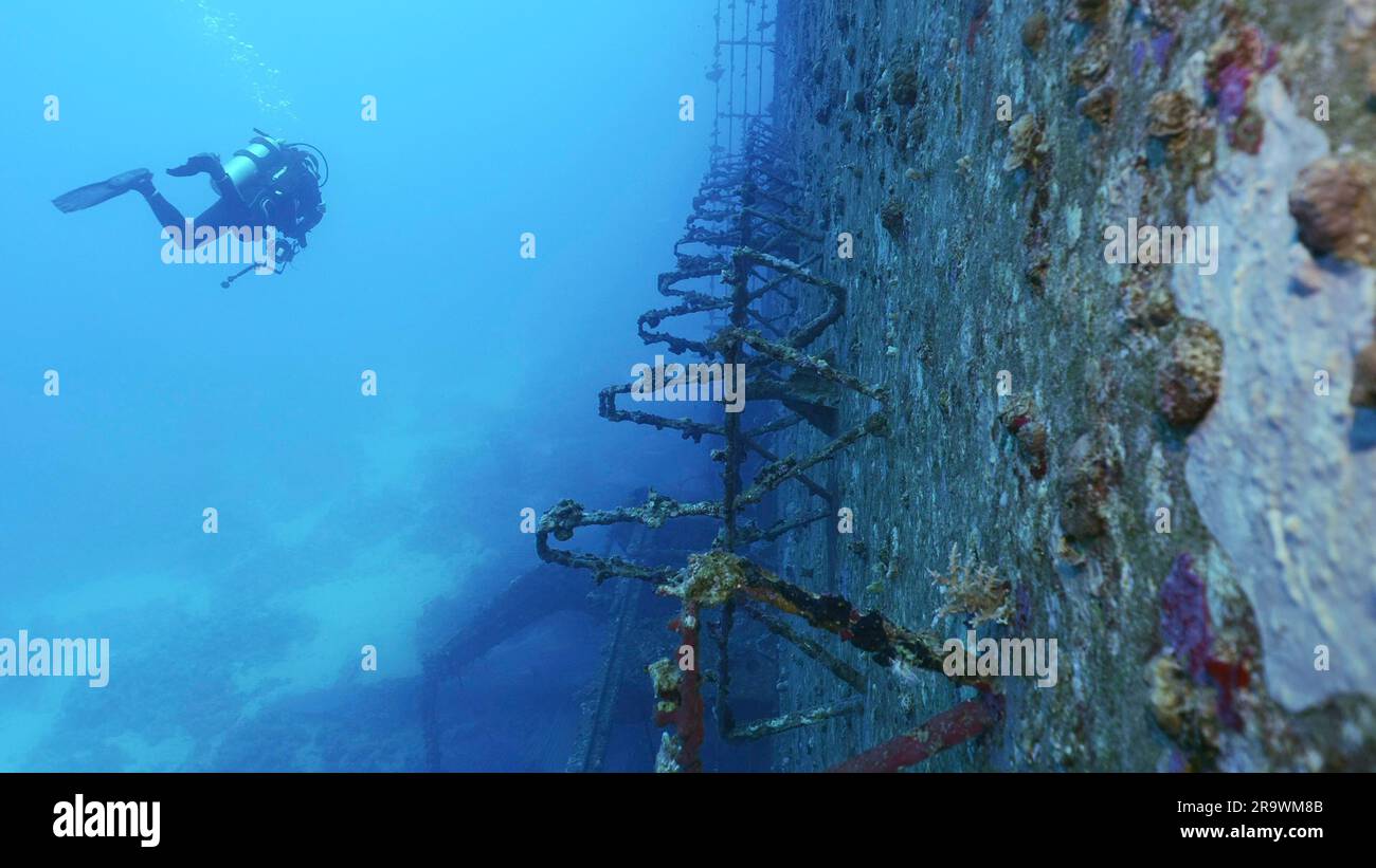 Scuba diver swim along deck of ferry Salem Express shipwreck ...