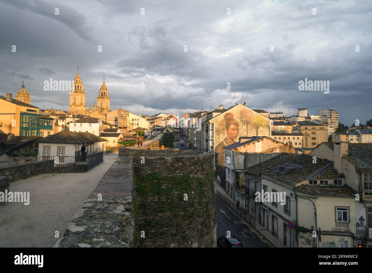 Roman wall with the cathedral in the background and the mural of a ...