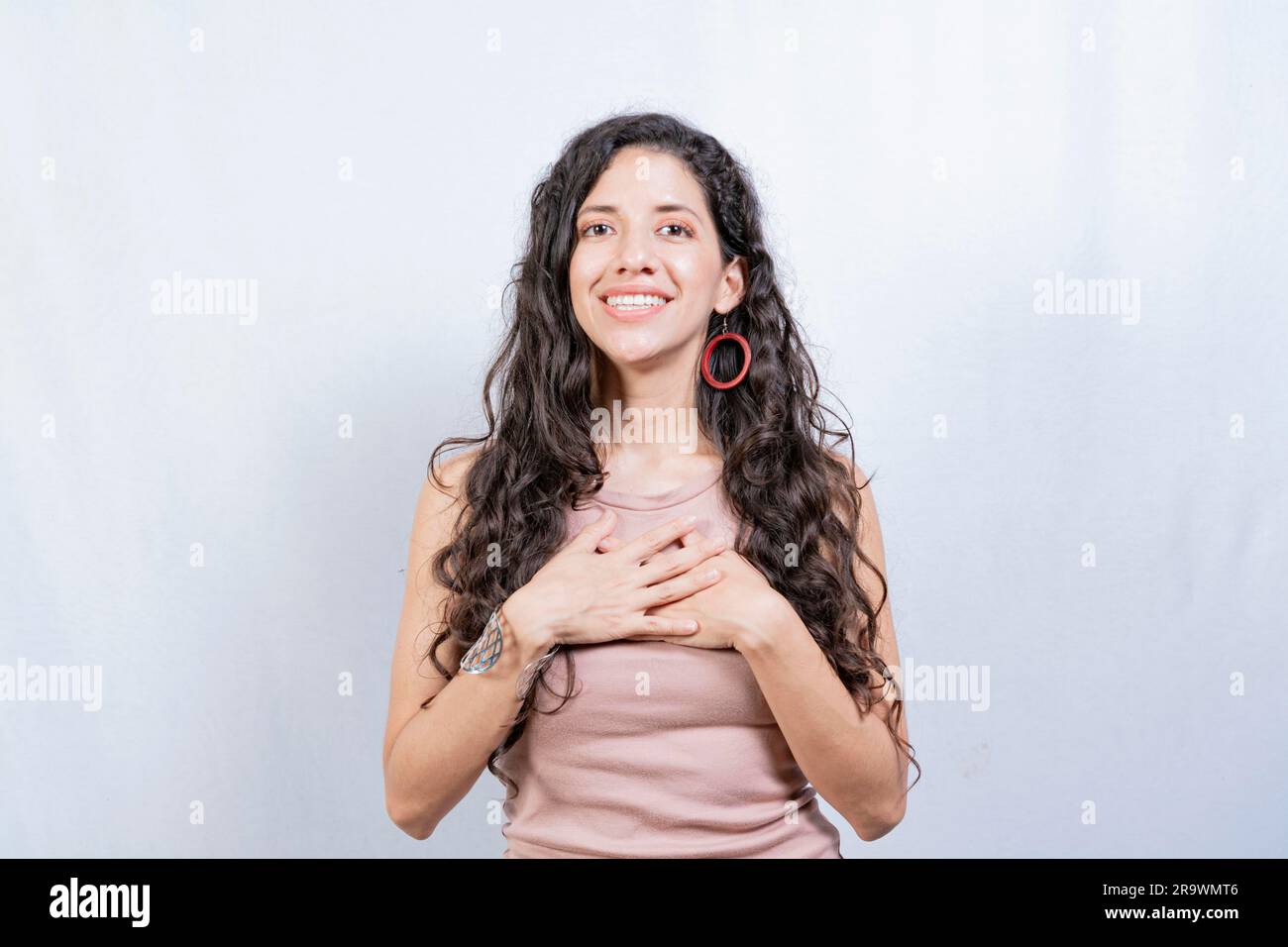 Positive woman with lovely sincere smile feeling thankful, relaxed ...