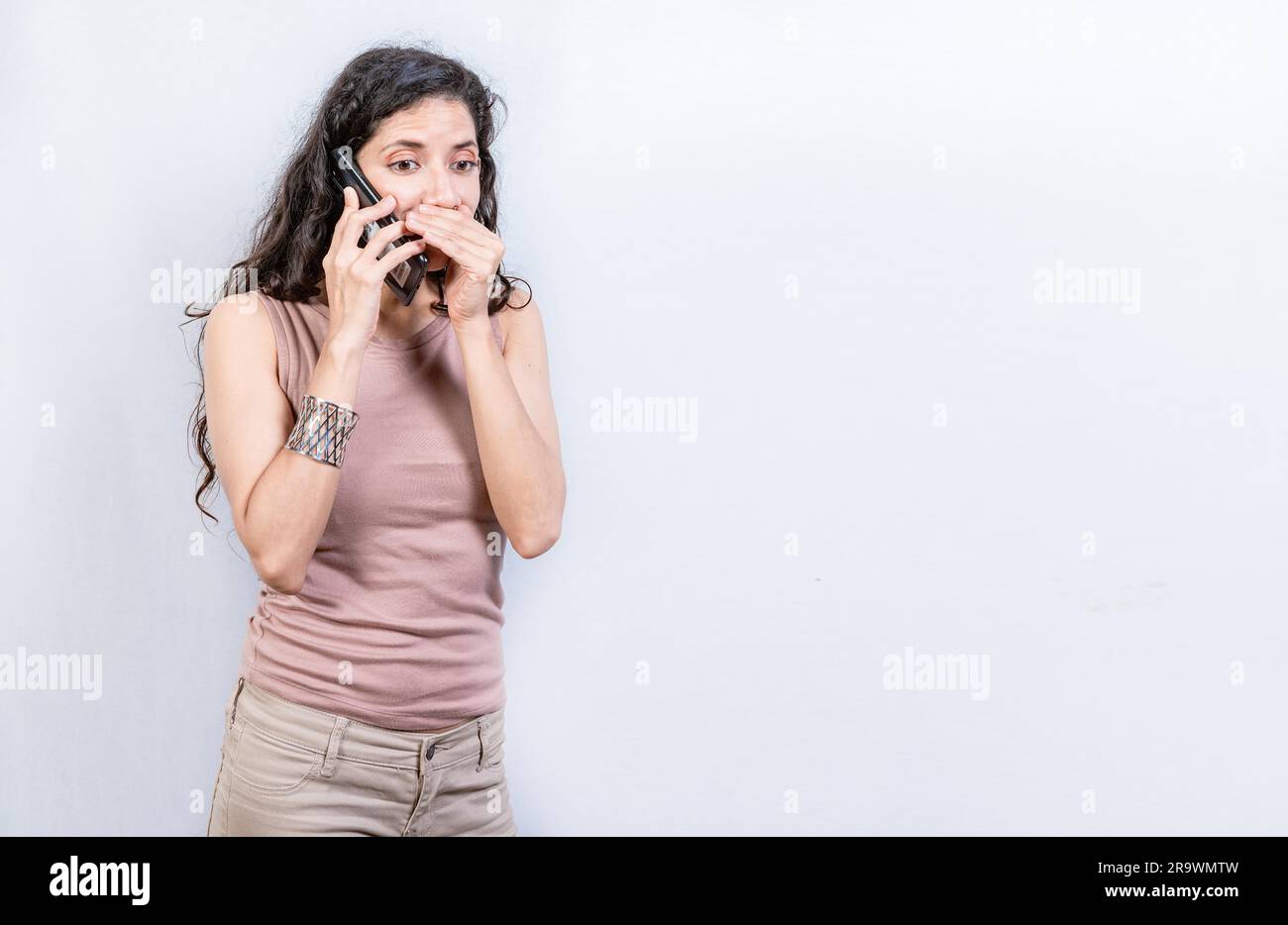 Mysterious young woman talking on the phone isolated. Woman talking ...