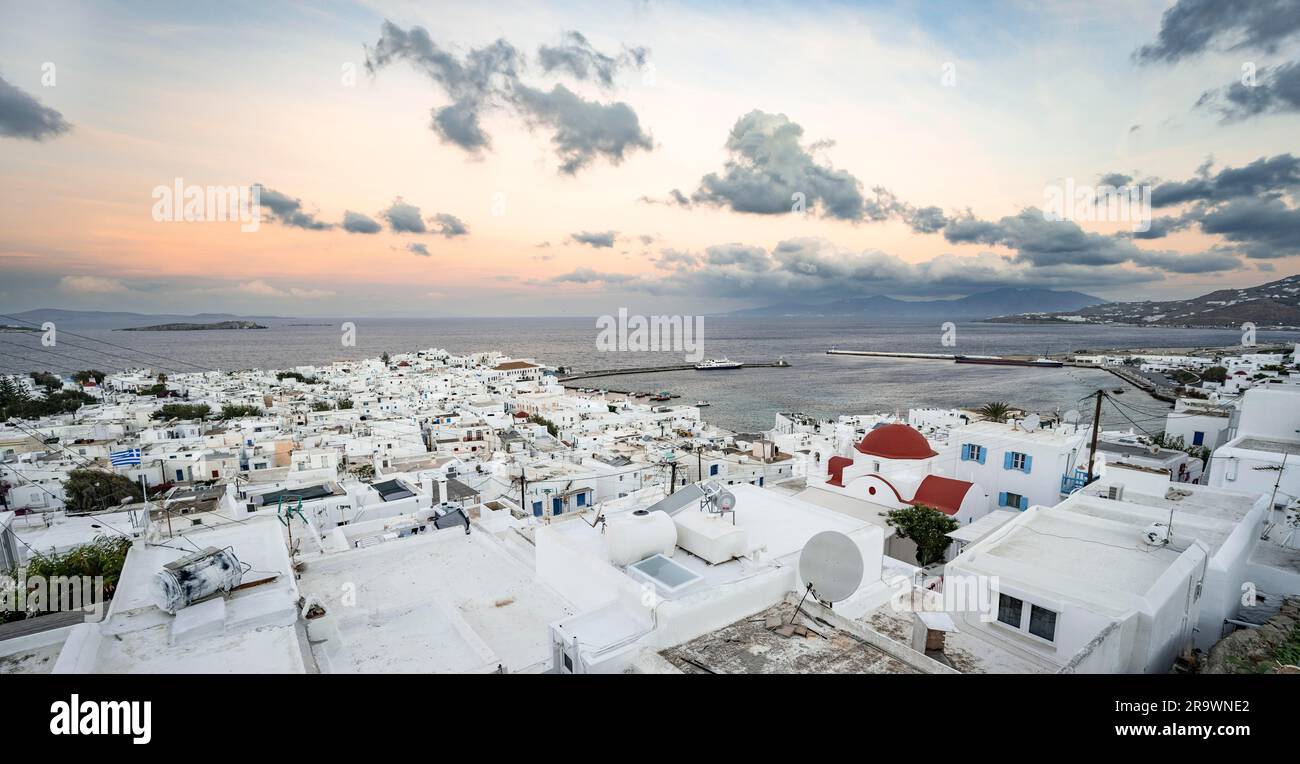 View over white Cycladic houses and harbour, at sunrise, panorama ...
