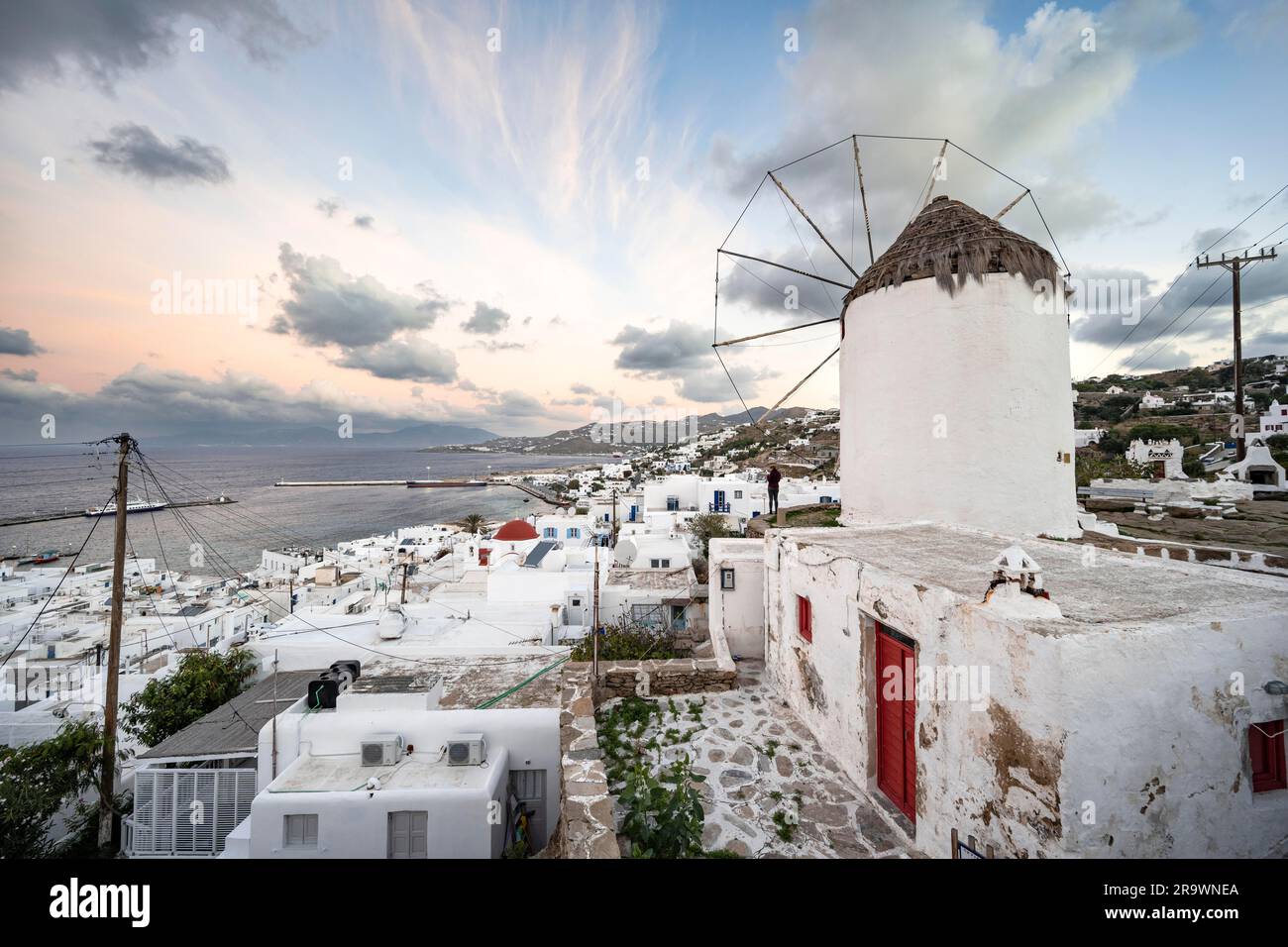 Bonis windmill at sunrise, view over white Cycladic houses, island and ...