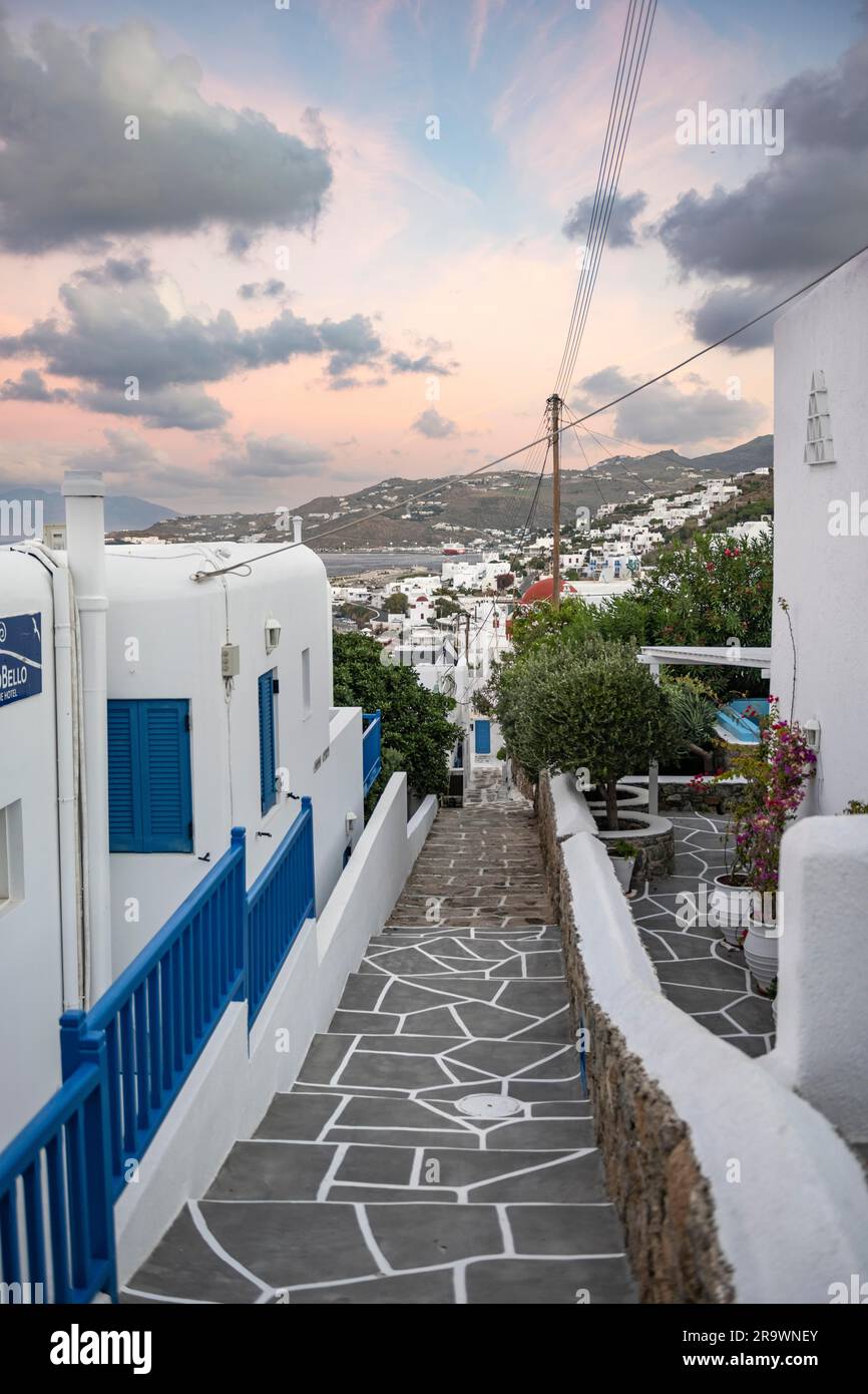 Cycladic white houses with colourful shutters, at sunrise, alleys of ...