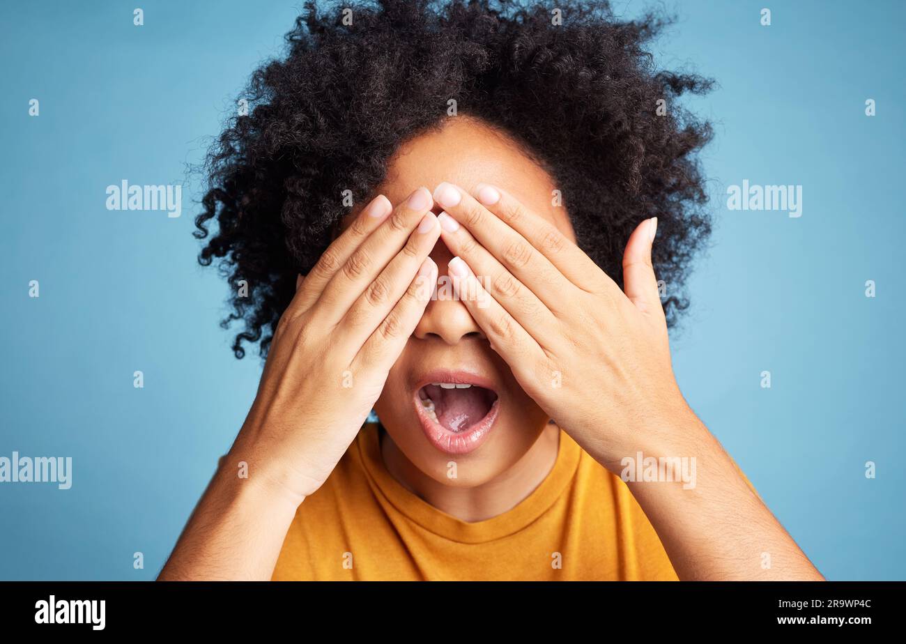 Shock, scared and woman closing her eyes in a studio for fear, horror ...