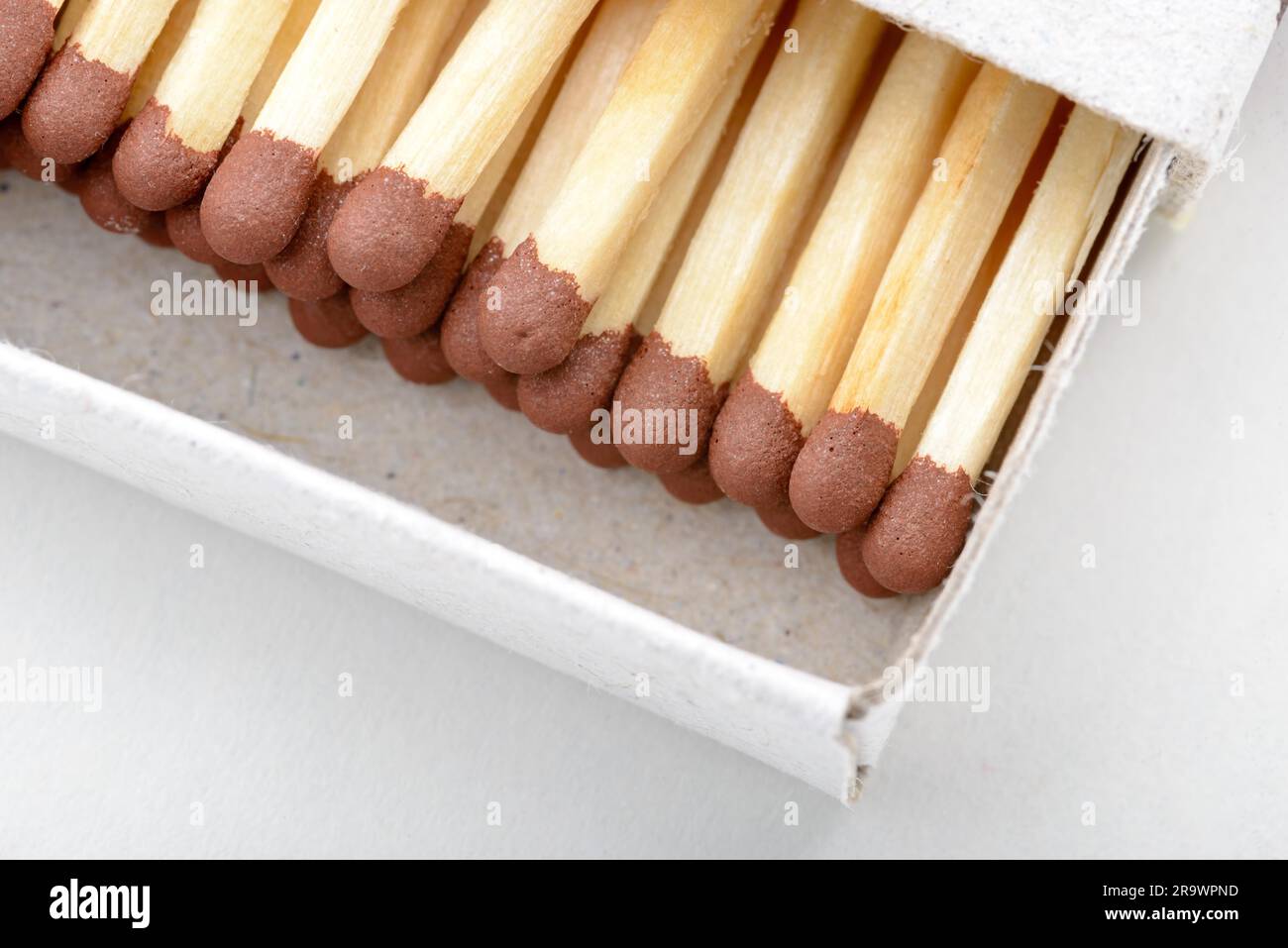 Matches in a cardboard matchbox on white paper background Stock Photo ...