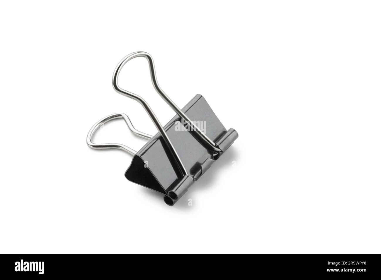 A black clip to attach documents together, isolated on white background ...