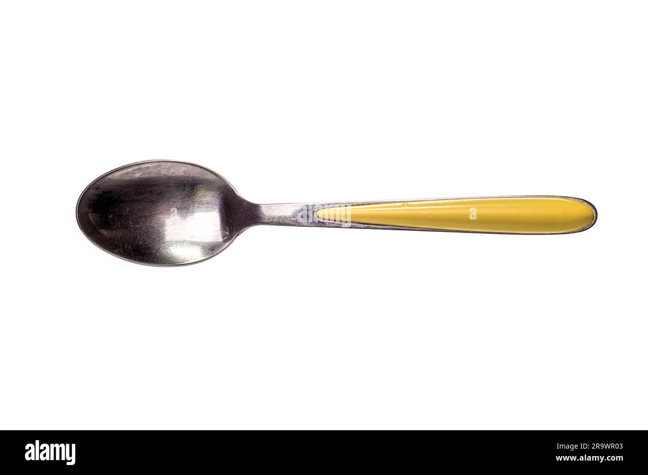 A metallic stainless inox tea spoon with yellow handle isolated on ...
