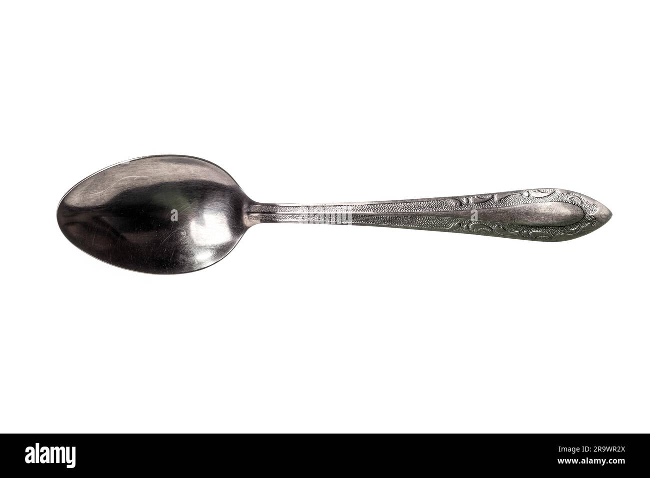 A soviet style metallic stainless inox spoon with decorations isolated ...