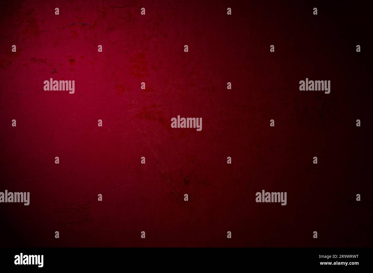 An antique dark red texture with light effect, to be used as background ...