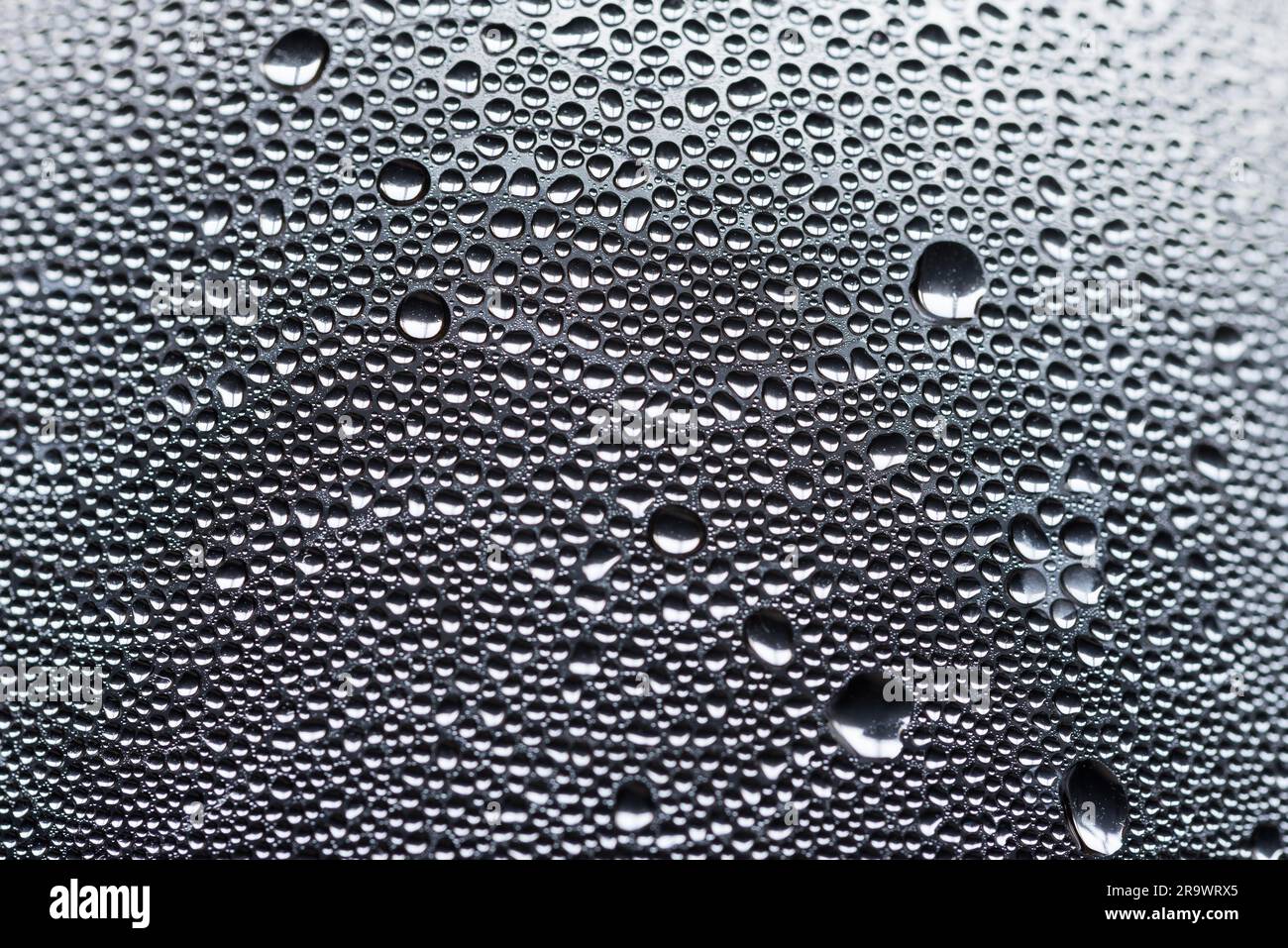 Many little water drops due to condensation on a plastic bottle curved ...