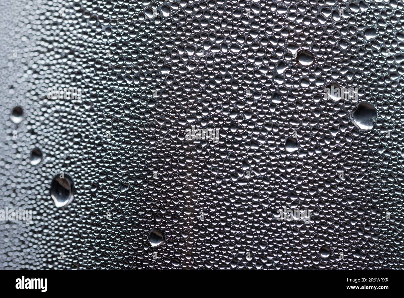 Many little water drops due to condensation on a plastic bottle curved ...