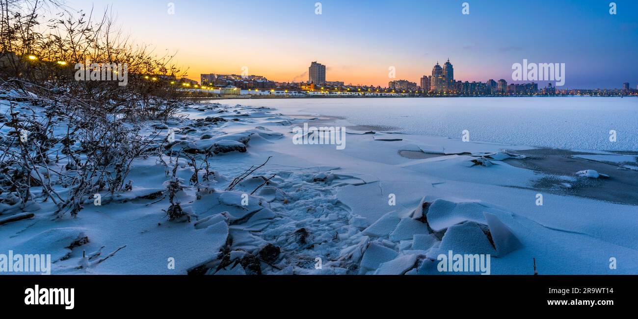 Cold Winter night cityscape with illuminated buildings in Kiev, Ukraine ...