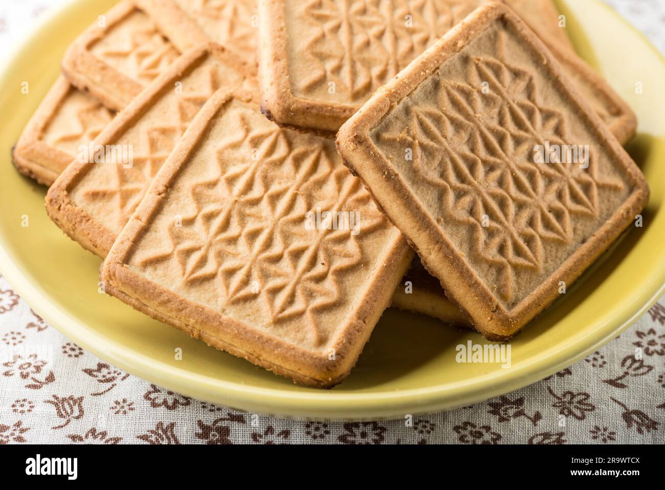 Traditional butter cookies in a yellow plate, for breakfast or tea time ...