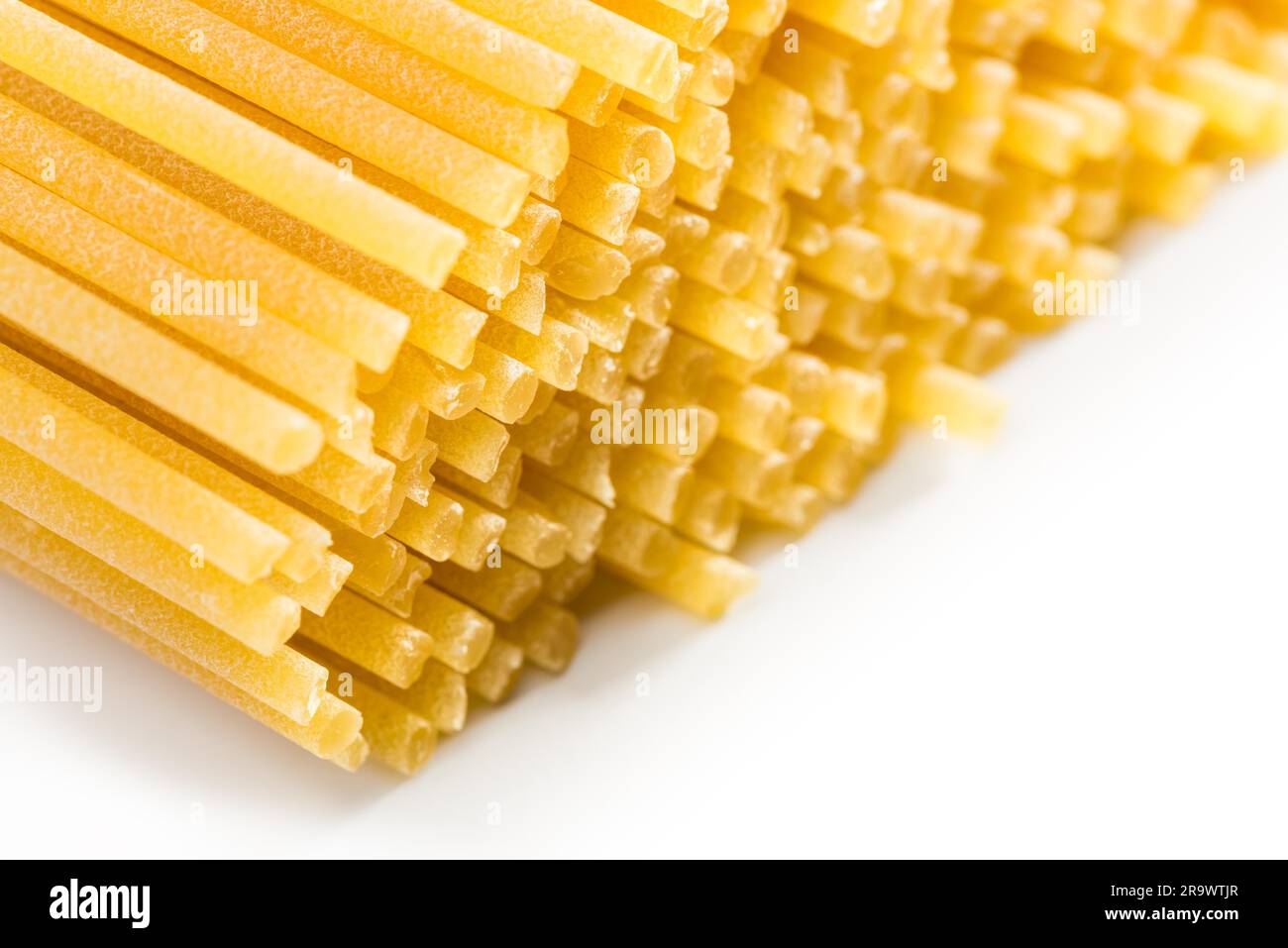 Italian spaghetti extruded through bronze, on white background Stock ...