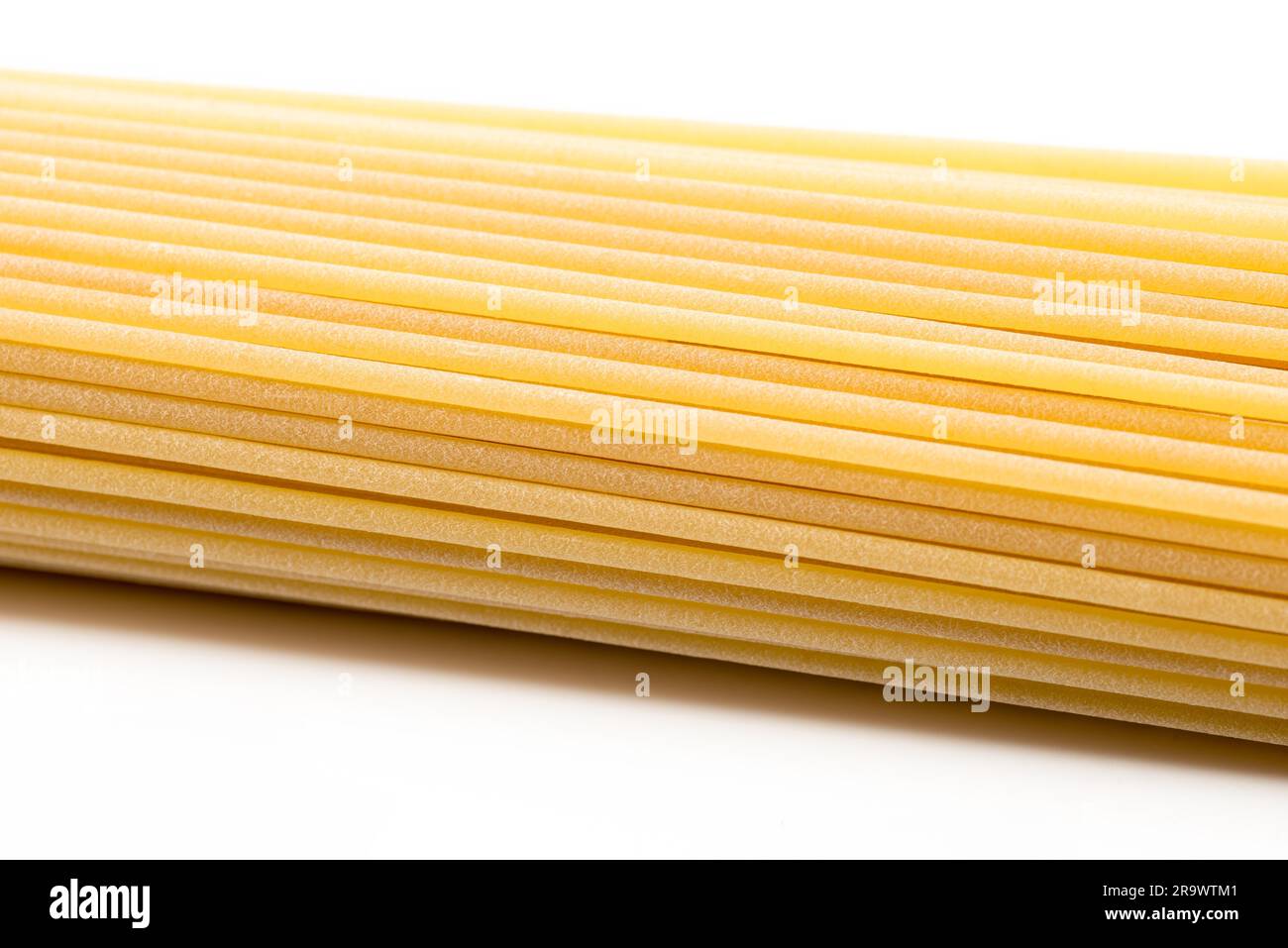 Italian spaghetti extruded through bronze, on white background Stock ...