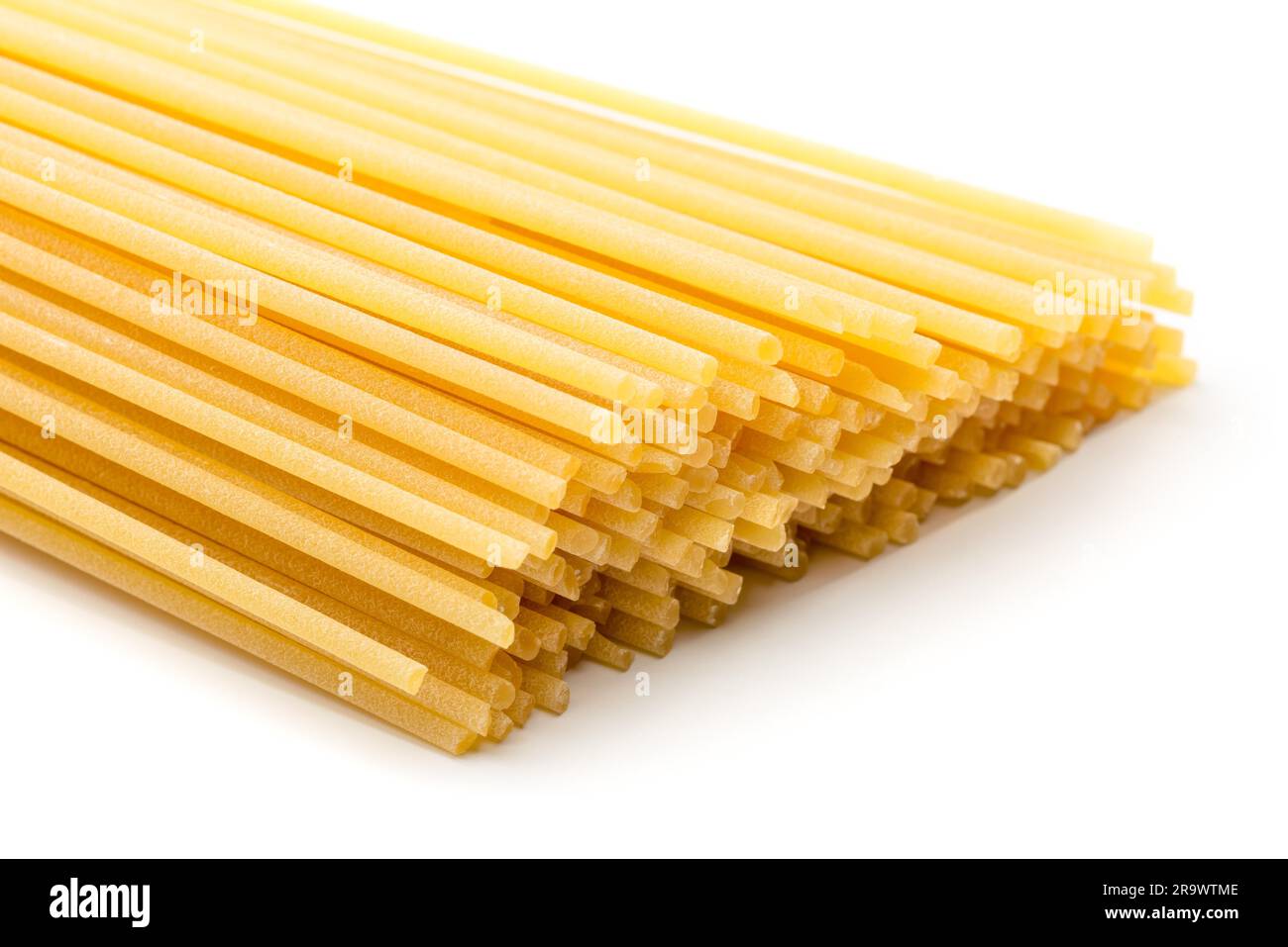 Italian spaghetti extruded through bronze, on white background Stock ...