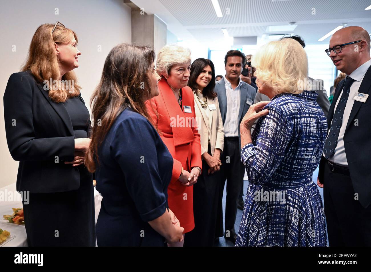 Queen Camilla speaks with former prime minister Theresa May during a ...