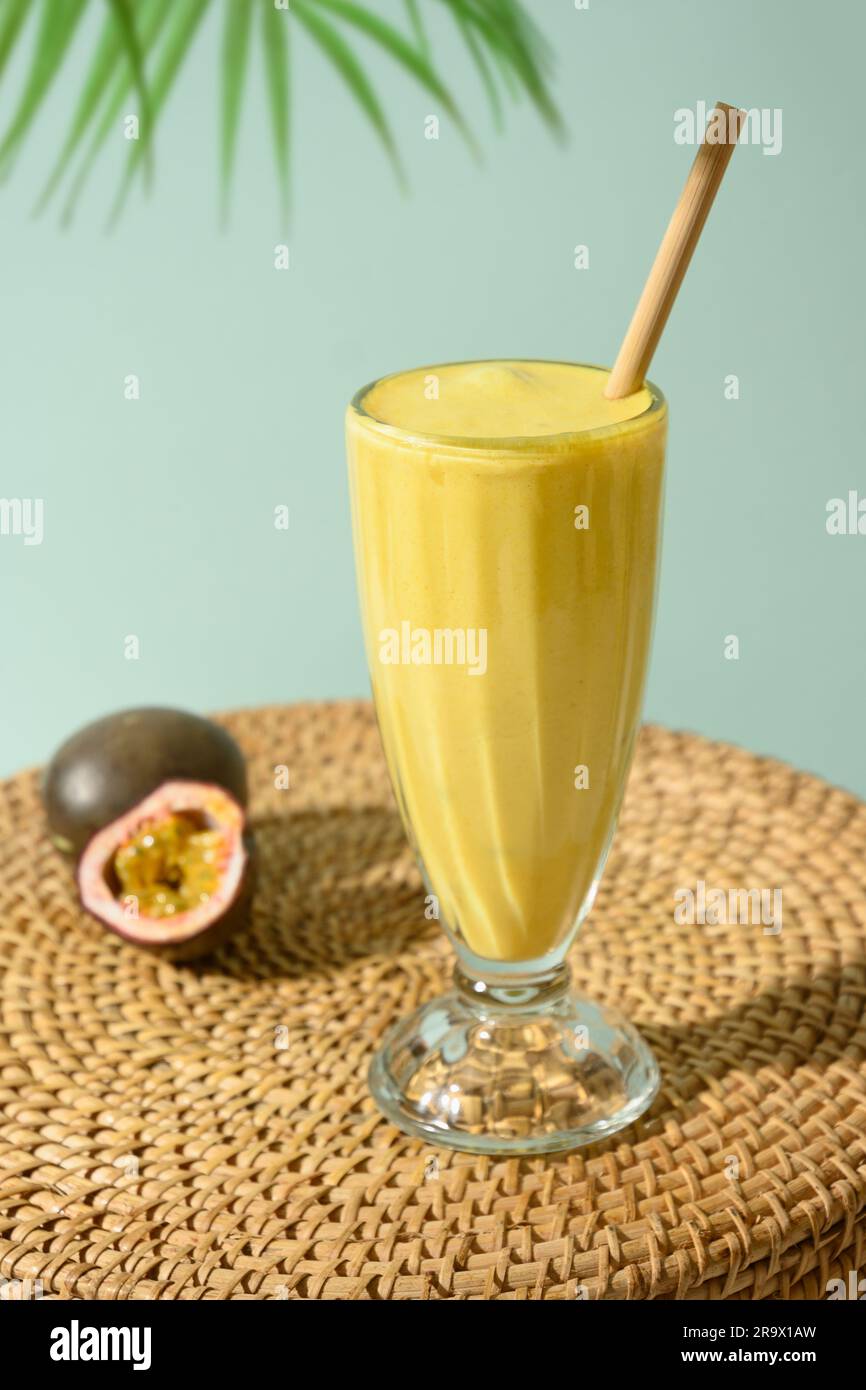 Passion Fruit Lassi in wicker tray on blue background. Vertical format ...